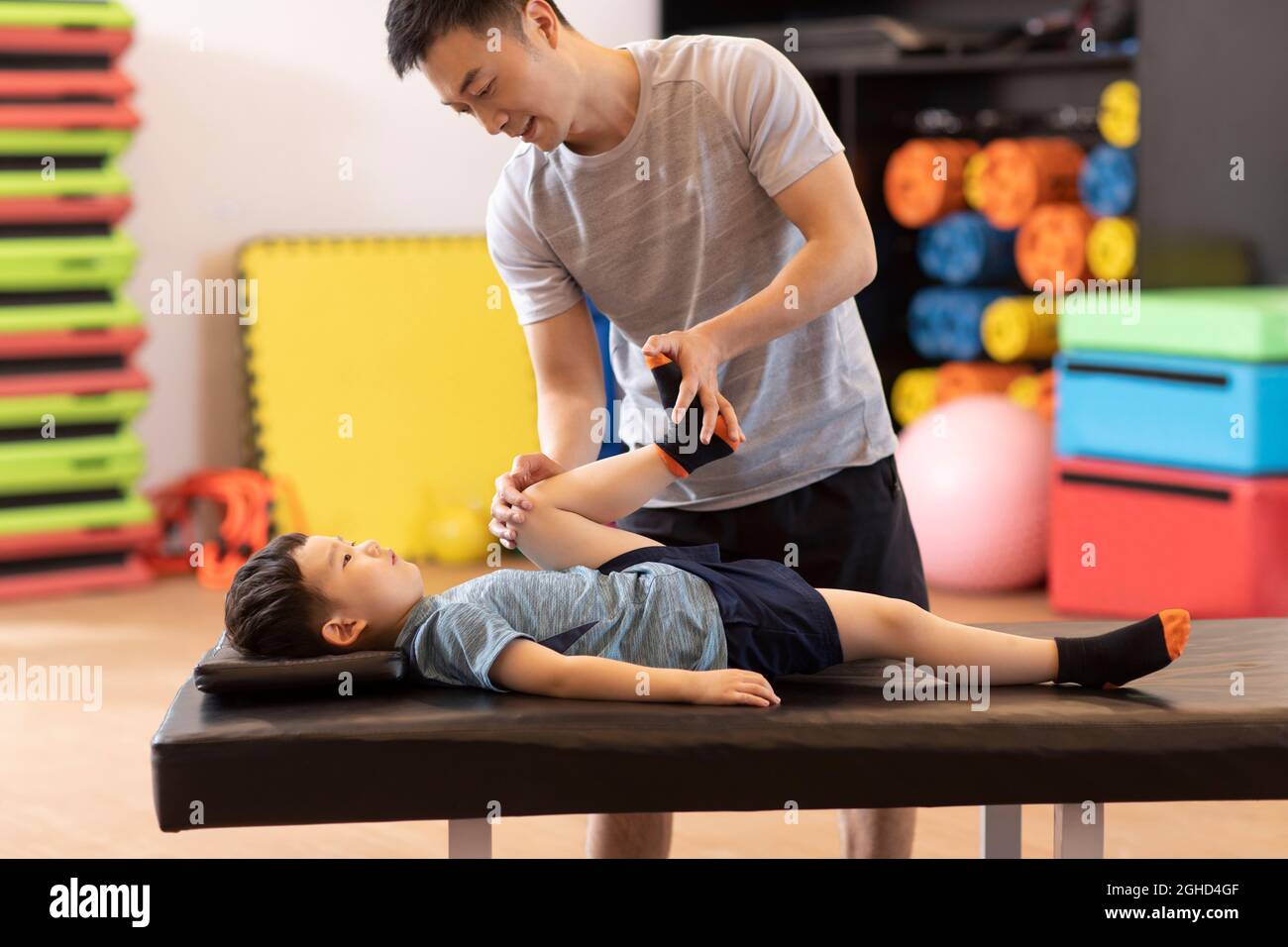 Little boy having exercise class in gym Stock Photo - Alamy