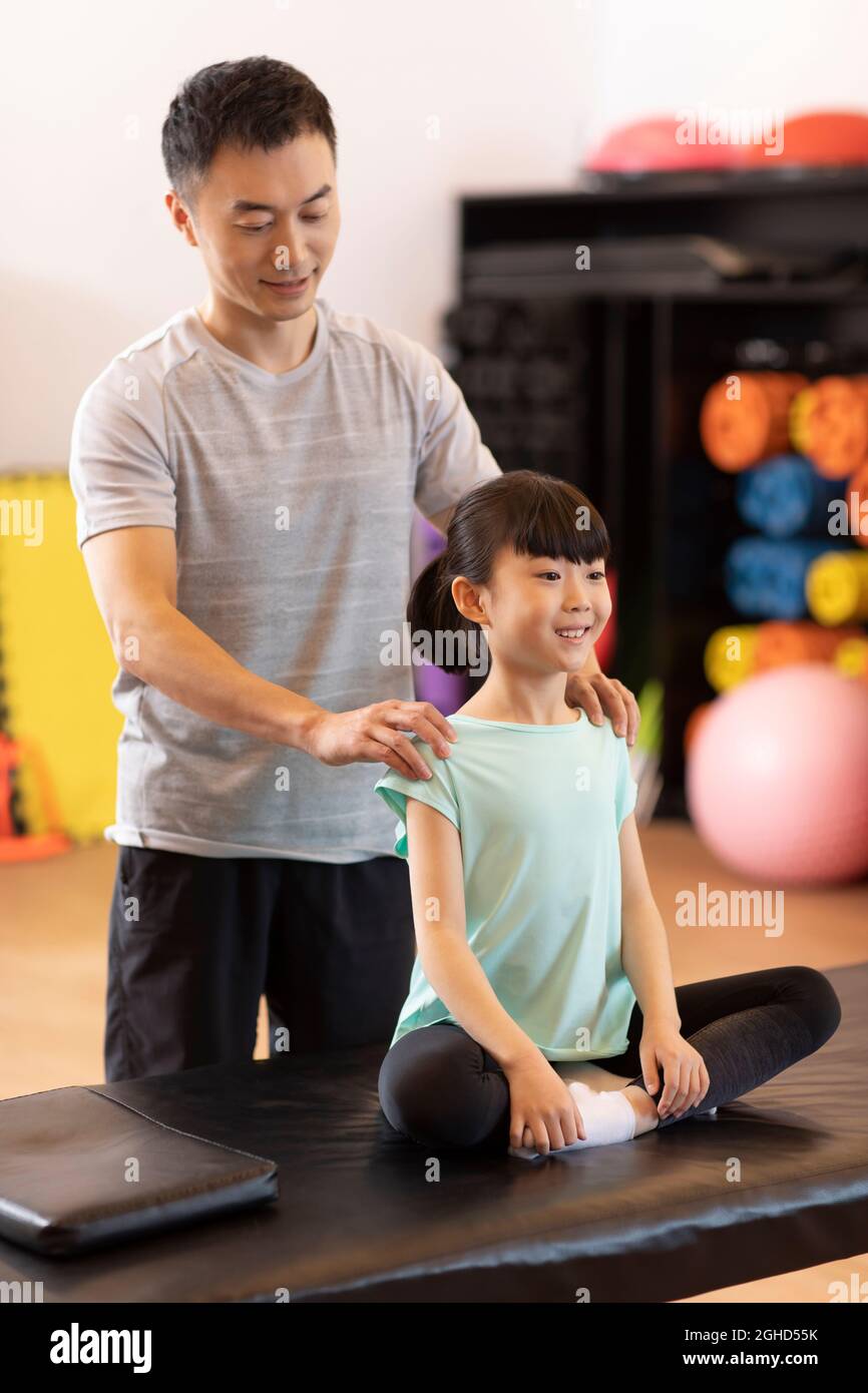 Little girl having exercise class in gym Stock Photo - Alamy
