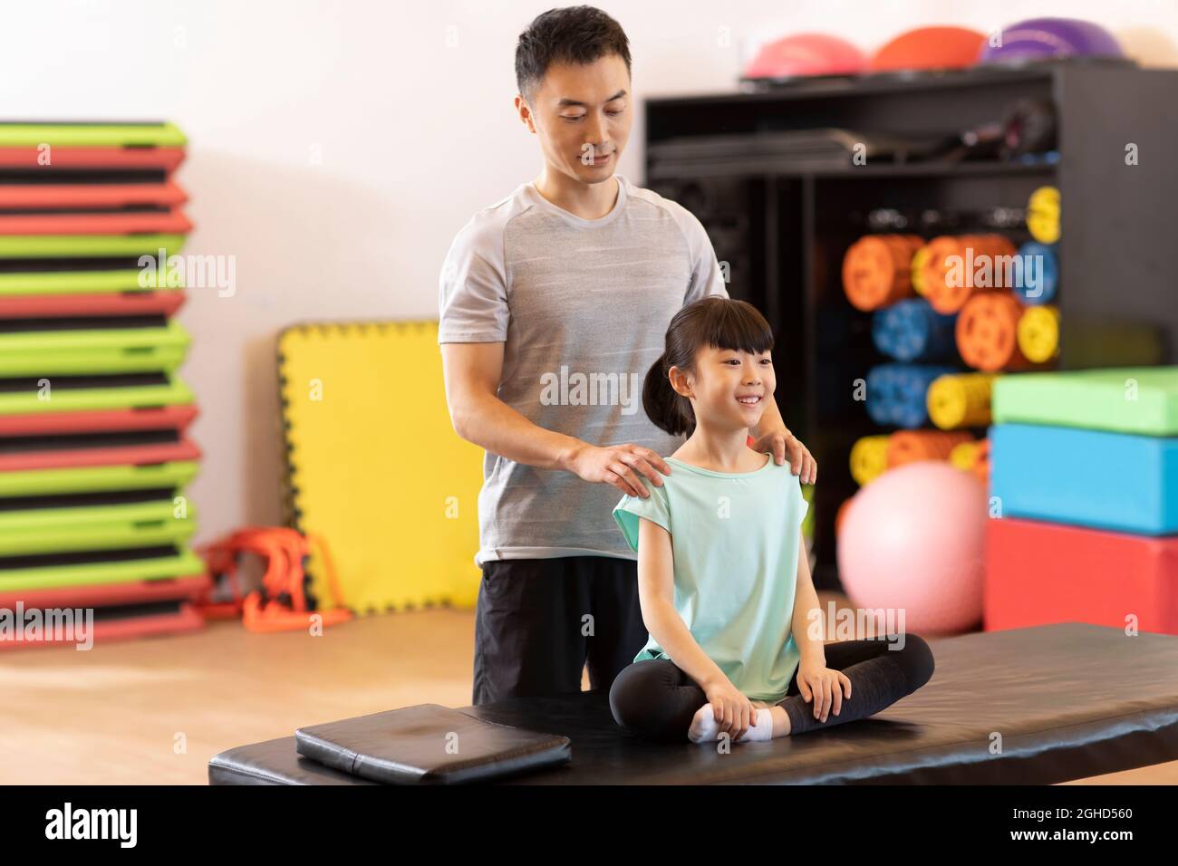 Little girl having exercise class in gym Stock Photo - Alamy
