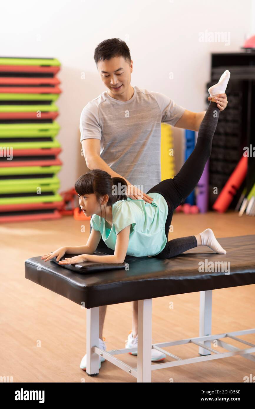 Little girl having exercise class in gym Stock Photo - Alamy