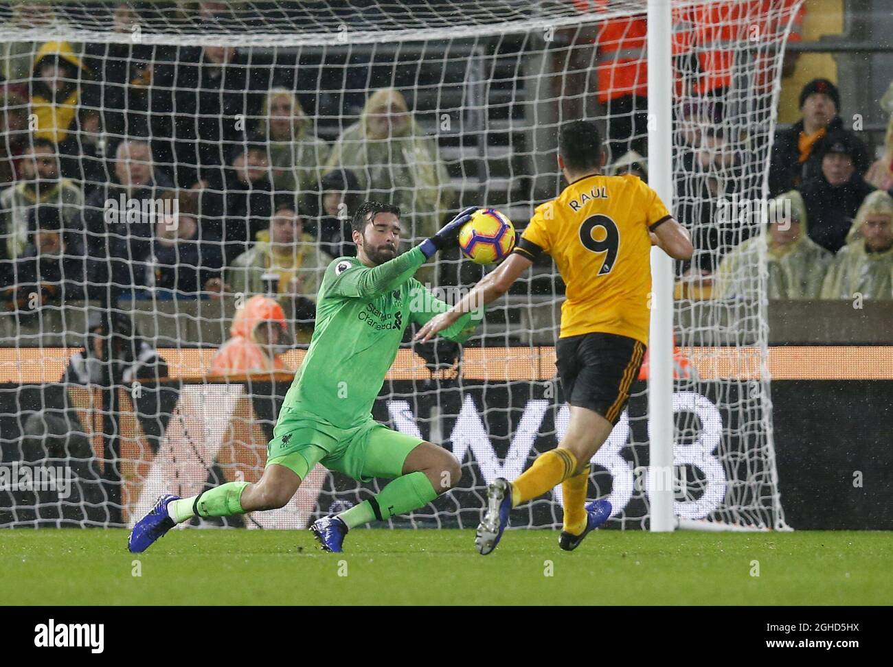 Alisson Becker of Liverpool makes a save from Raul Jimenez of ...