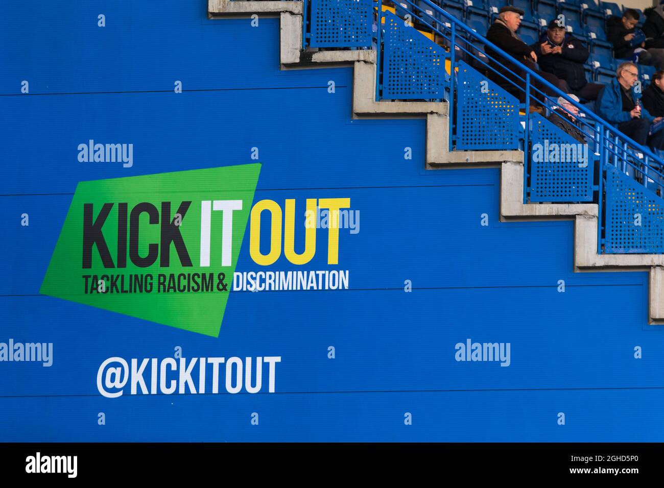 A sign saying "Kick it out - tackling racism and discrimination" is ...