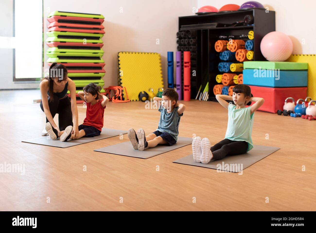 Cute children having exercise class in gym Stock Photo - Alamy