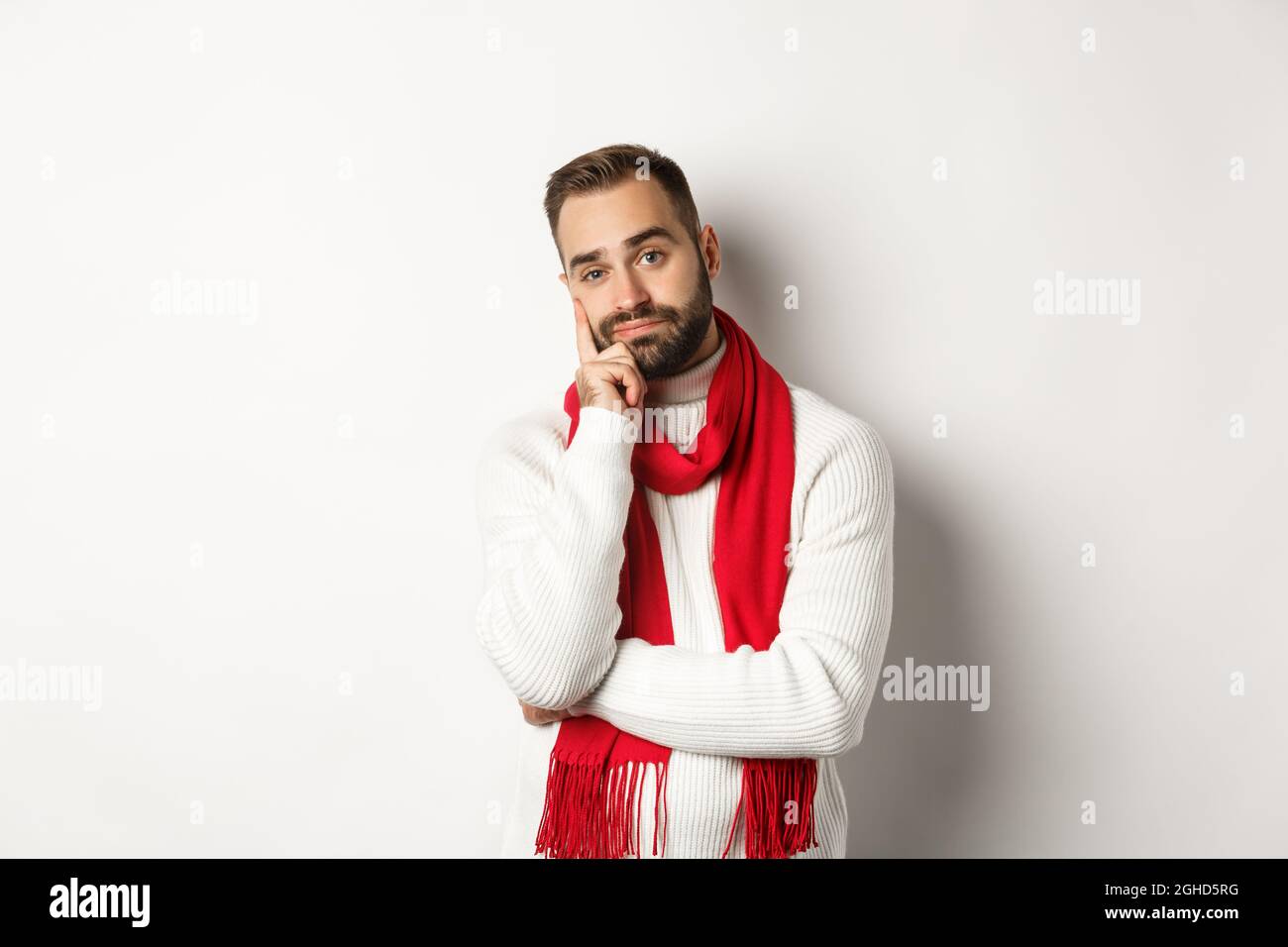 Bored young man looking indifferent and tired at camera, listening ...