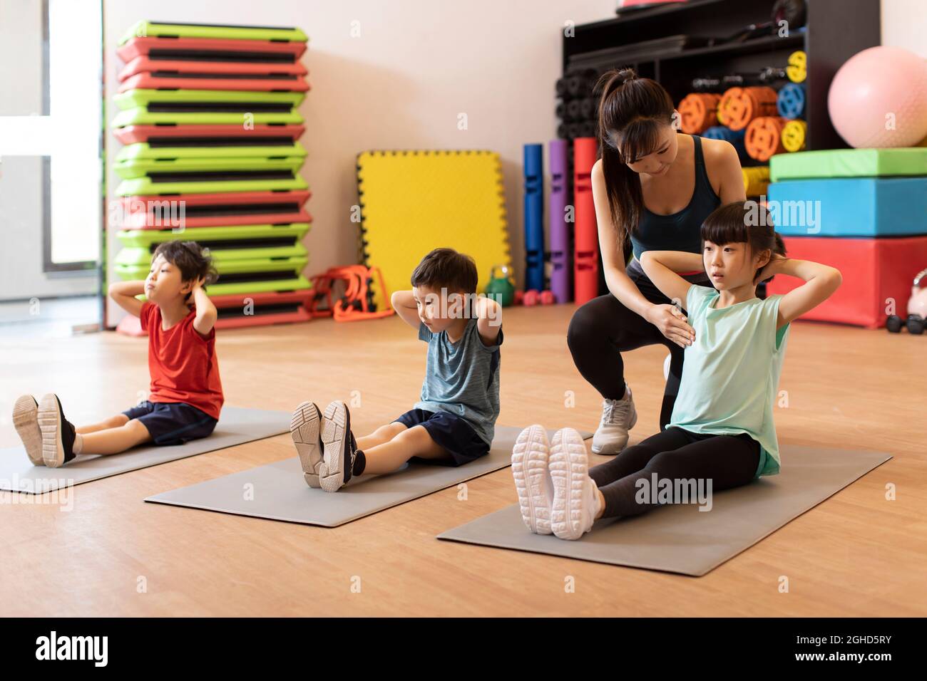 Cute children having exercise class in gym Stock Photo - Alamy