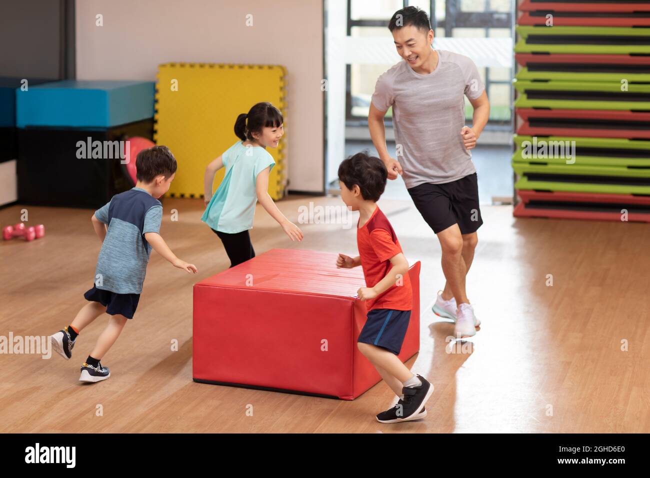 Cute children having exercise class in gym Stock Photo - Alamy