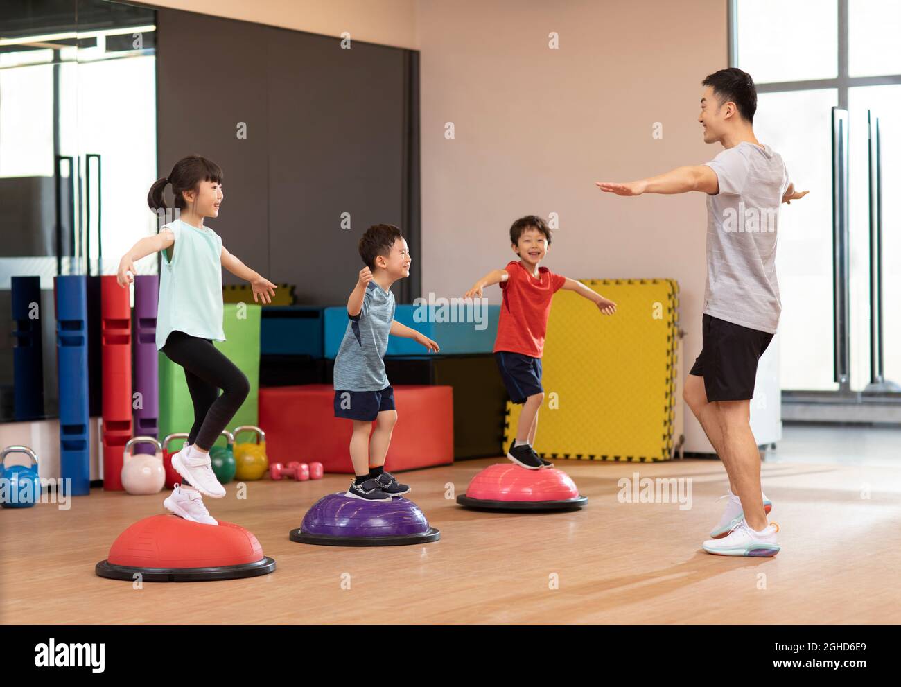 Cute children having exercise class in gym Stock Photo - Alamy