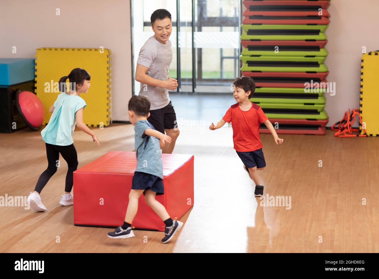 Cute children having exercise class in gym Stock Photo - Alamy