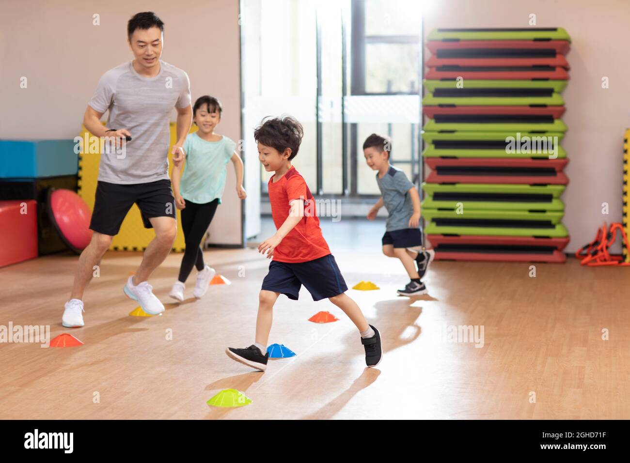 Cute children having exercise class in gym Stock Photo - Alamy