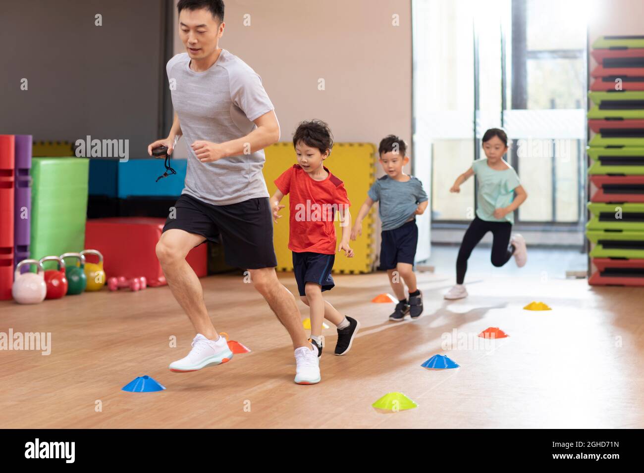 Cute children having exercise class in gym Stock Photo - Alamy