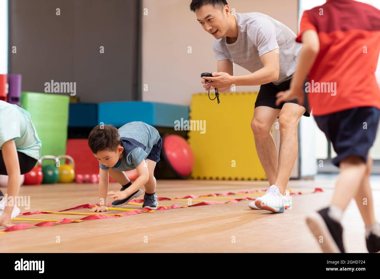 Cute children having exercise class in gym Stock Photo - Alamy