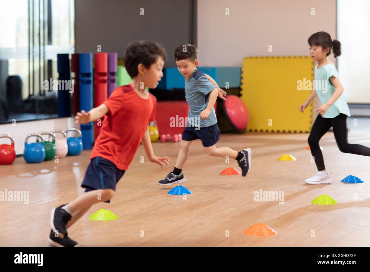 Cute children having exercise class in gym Stock Photo - Alamy