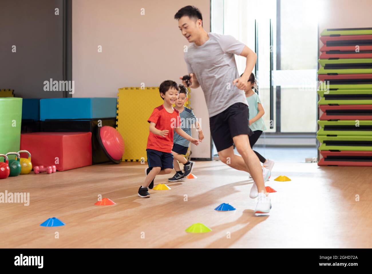 Cute children having exercise class in gym Stock Photo - Alamy