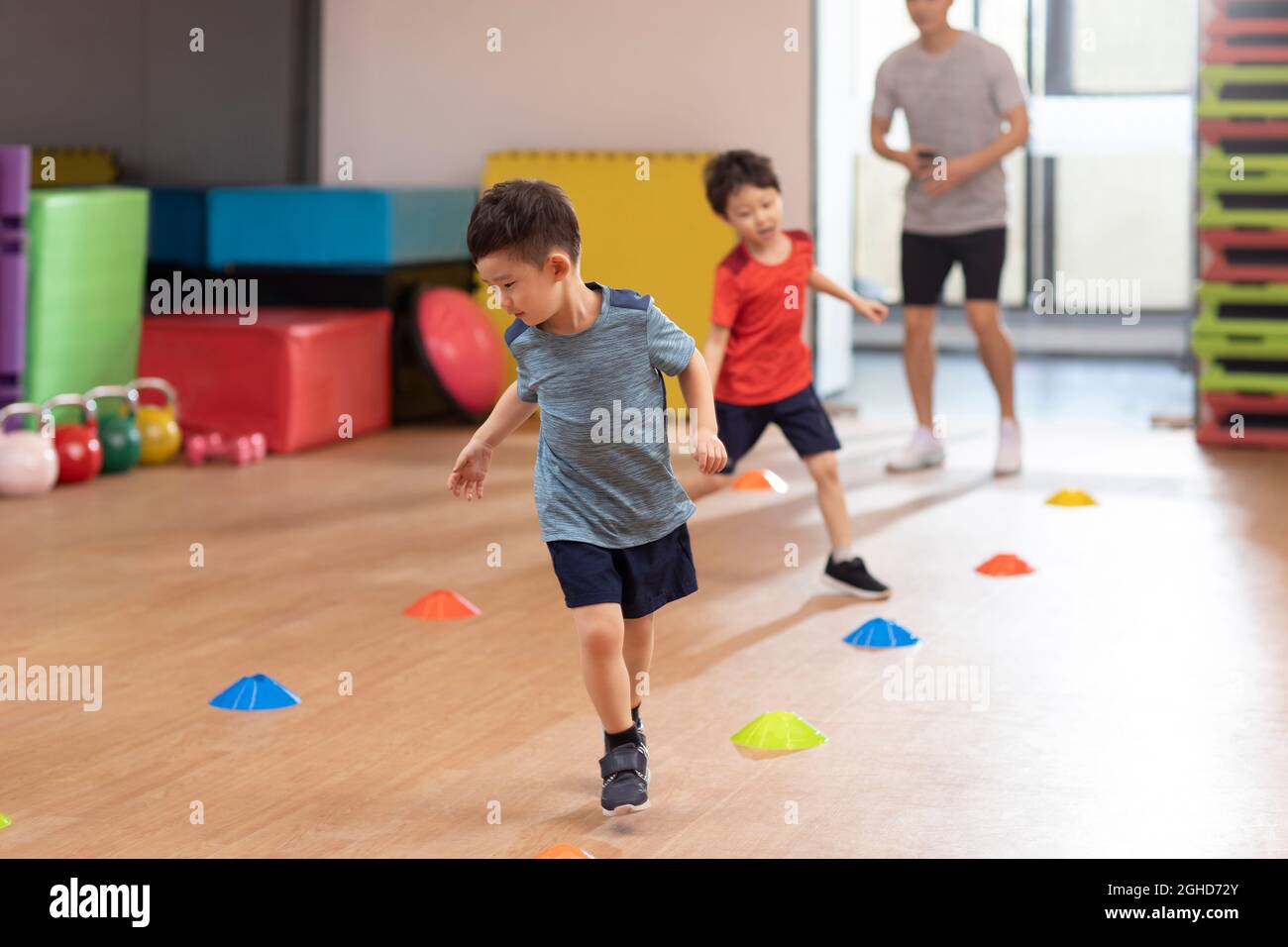 Cute children having exercise class in gym Stock Photo - Alamy