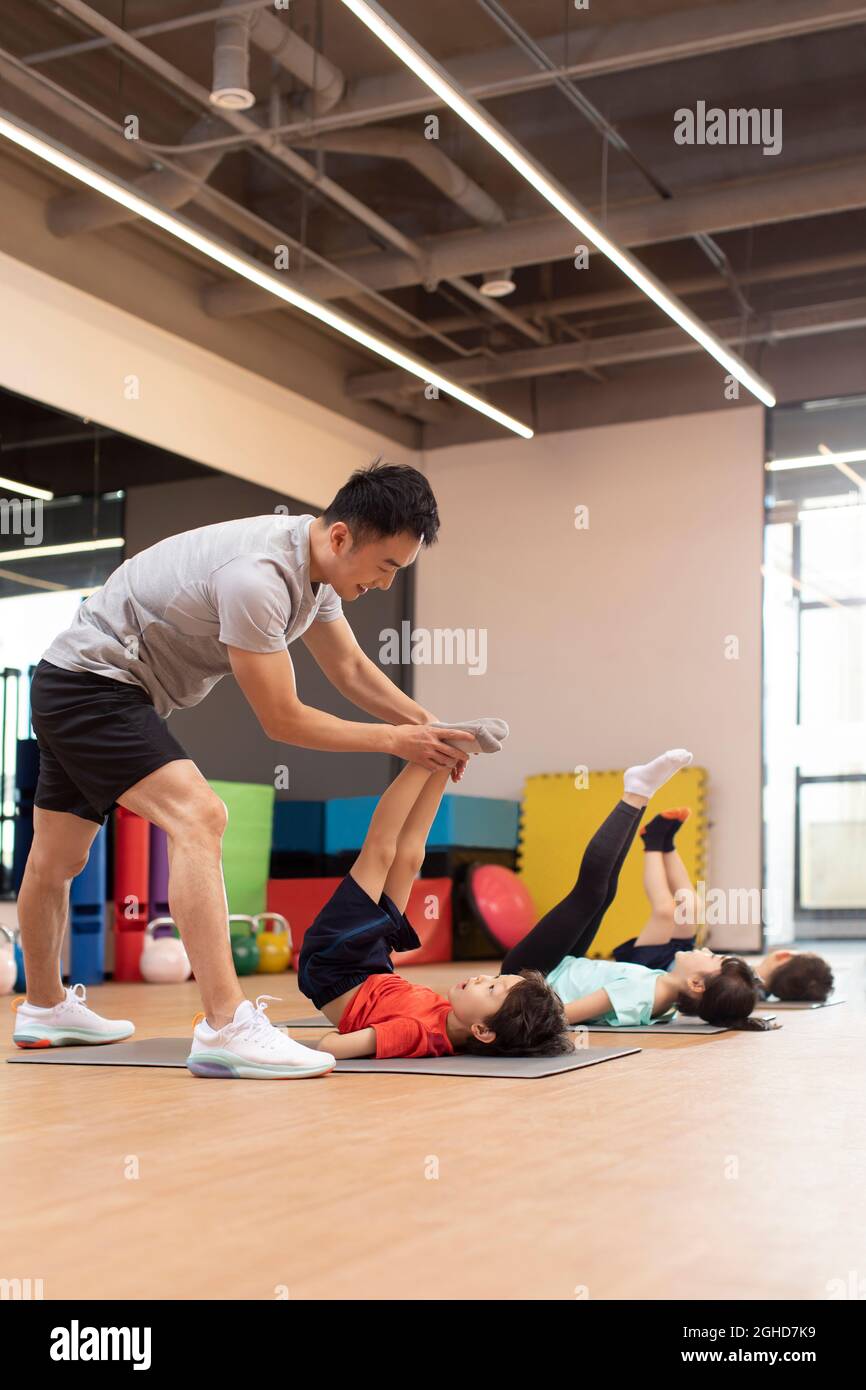 Cute children having exercise class in gym Stock Photo - Alamy