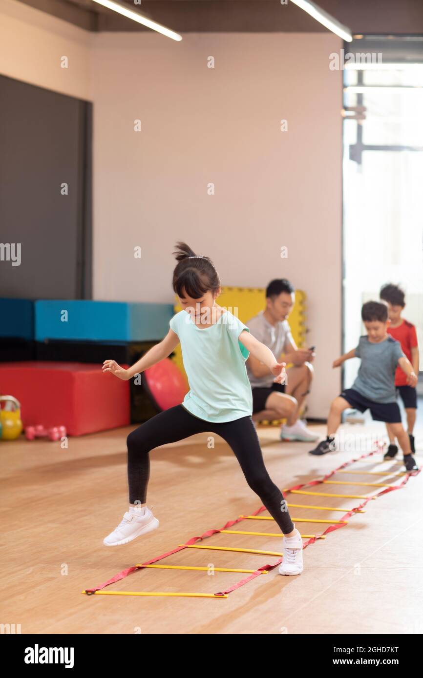 Cute children having exercise class in gym Stock Photo - Alamy