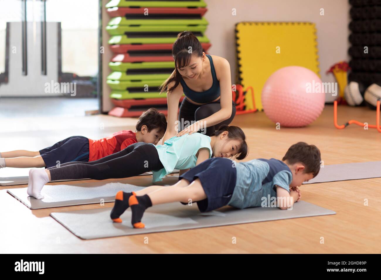 Cute children having exercise class in gym Stock Photo - Alamy