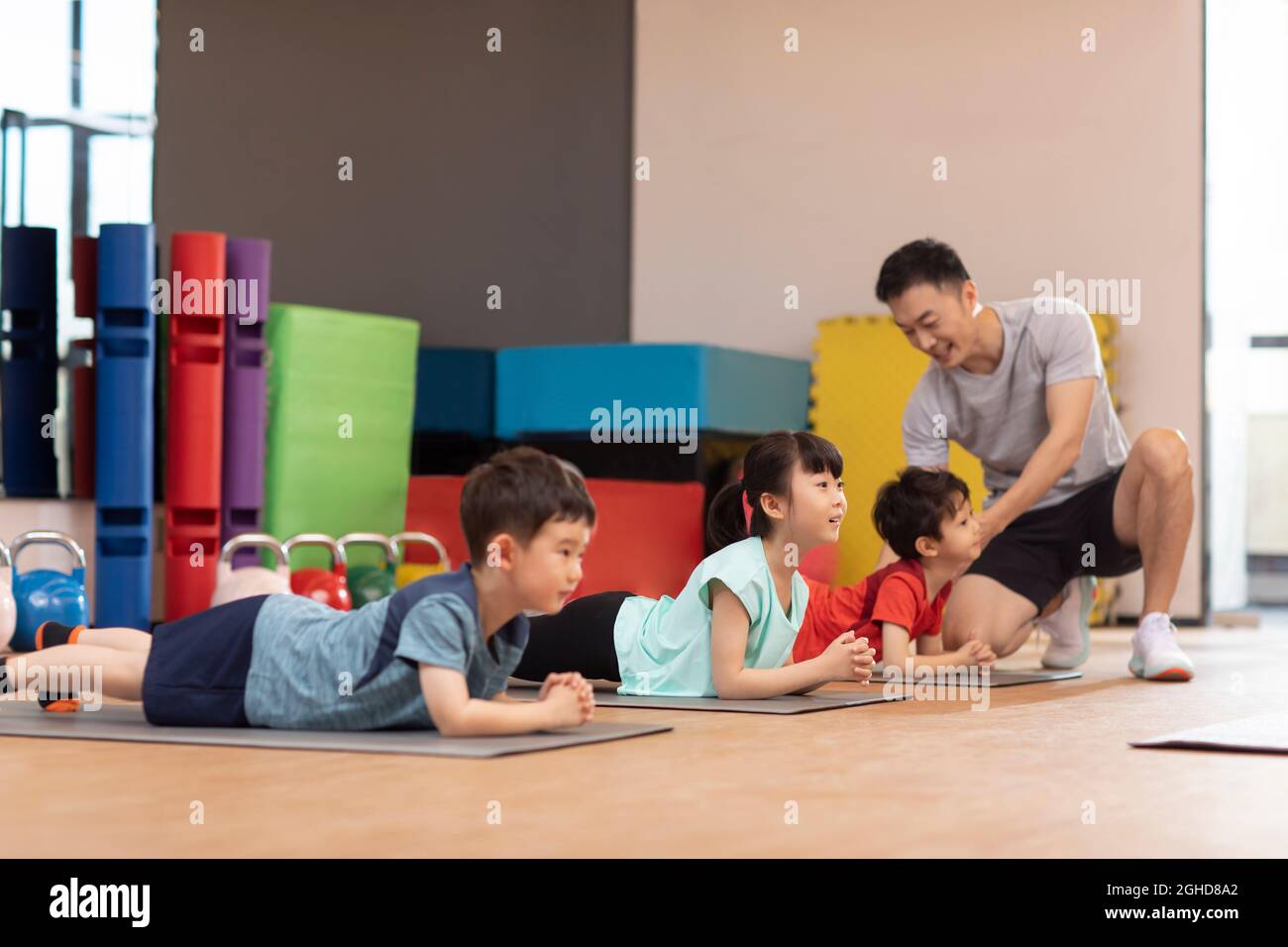 Cute children having exercise class in gym Stock Photo - Alamy