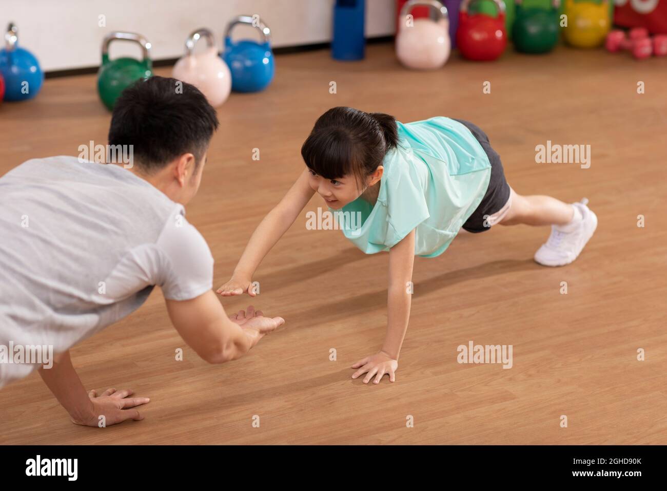 Little girl having exercise class in gym Stock Photo - Alamy