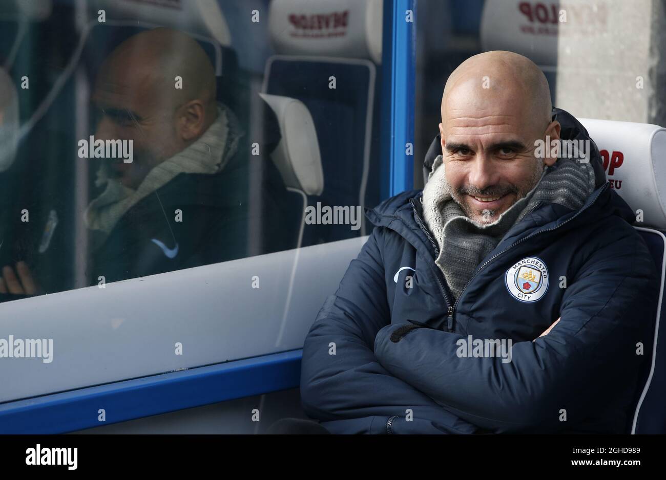 Josep Guardiola manager of Manchester City reflected in the dugout ...