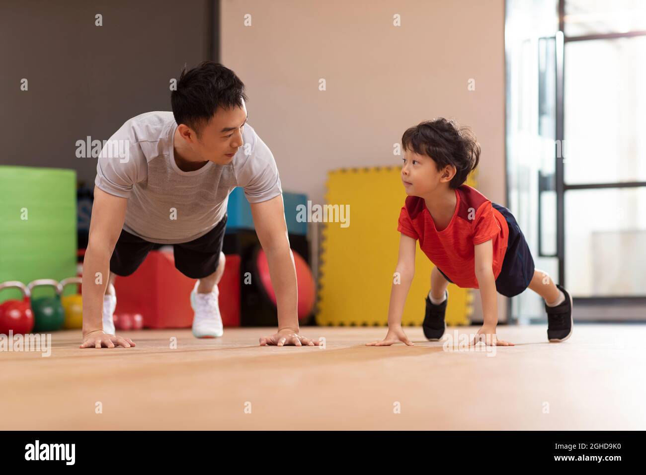 Little boy having exercise class in gym Stock Photo - Alamy
