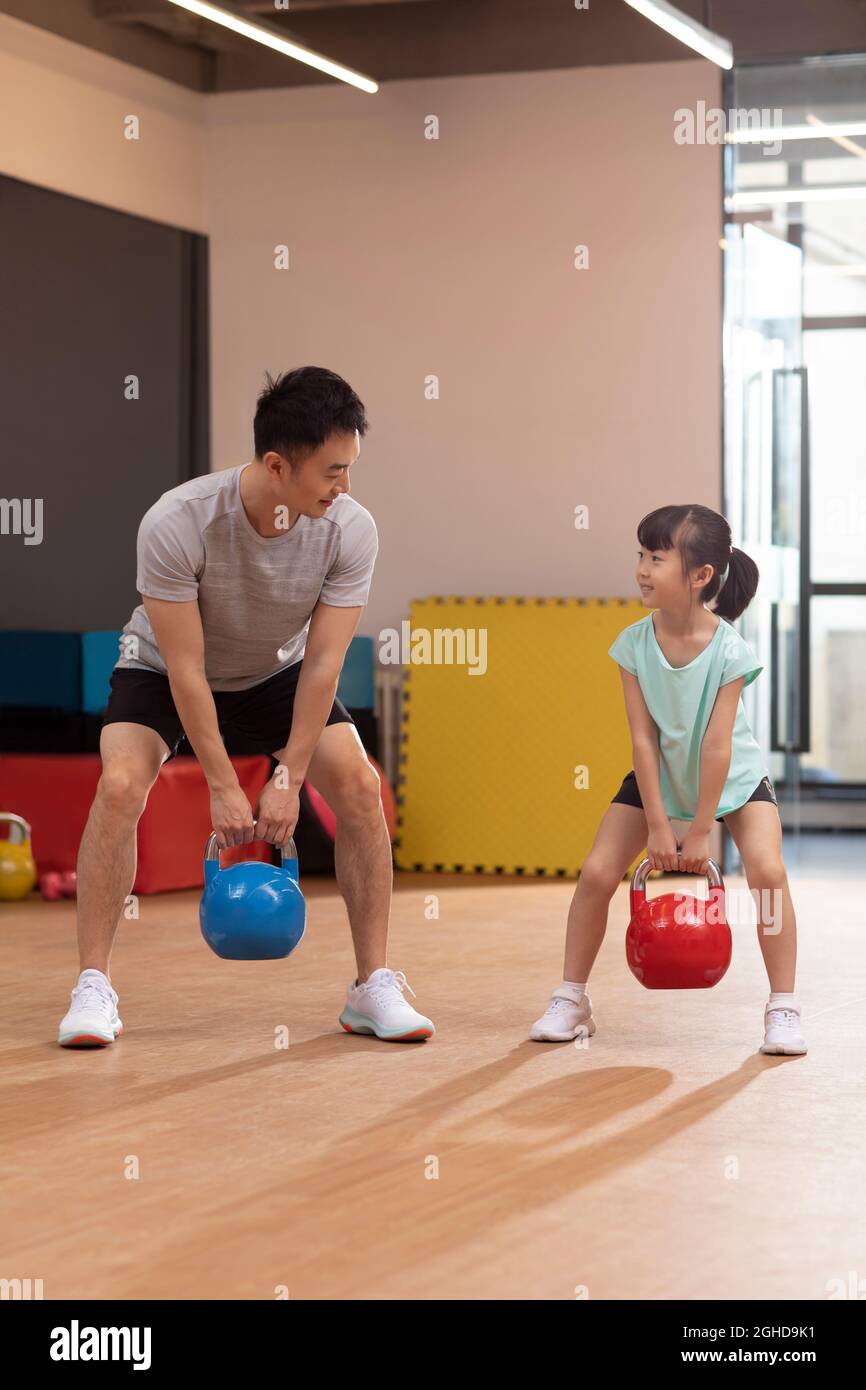Little girl having exercise class in gym Stock Photo - Alamy