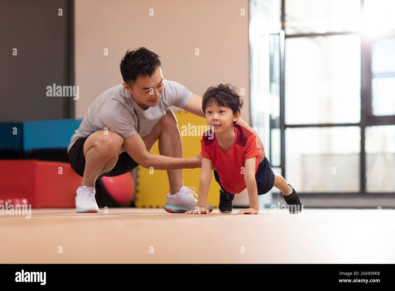 Little boy having exercise class in gym Stock Photo - Alamy
