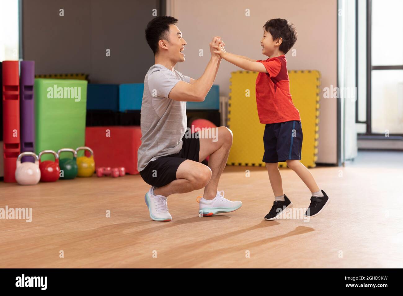 Little boy having exercise class in gym Stock Photo - Alamy