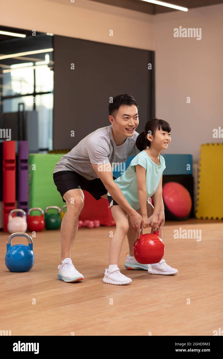 Little girl having exercise class in gym Stock Photo - Alamy