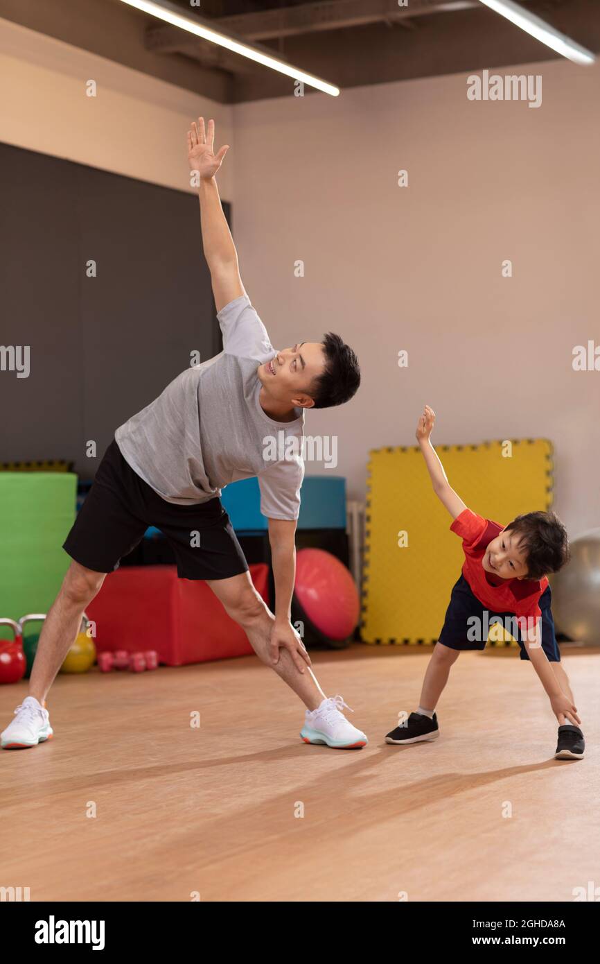 Little boy exercising with his father in gym Stock Photo - Alamy