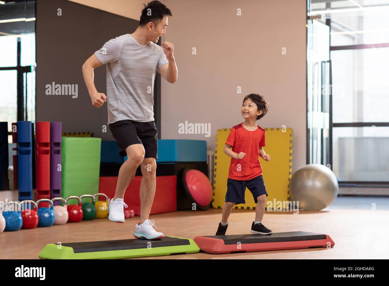 Little boy having exercise class in gym Stock Photo - Alamy