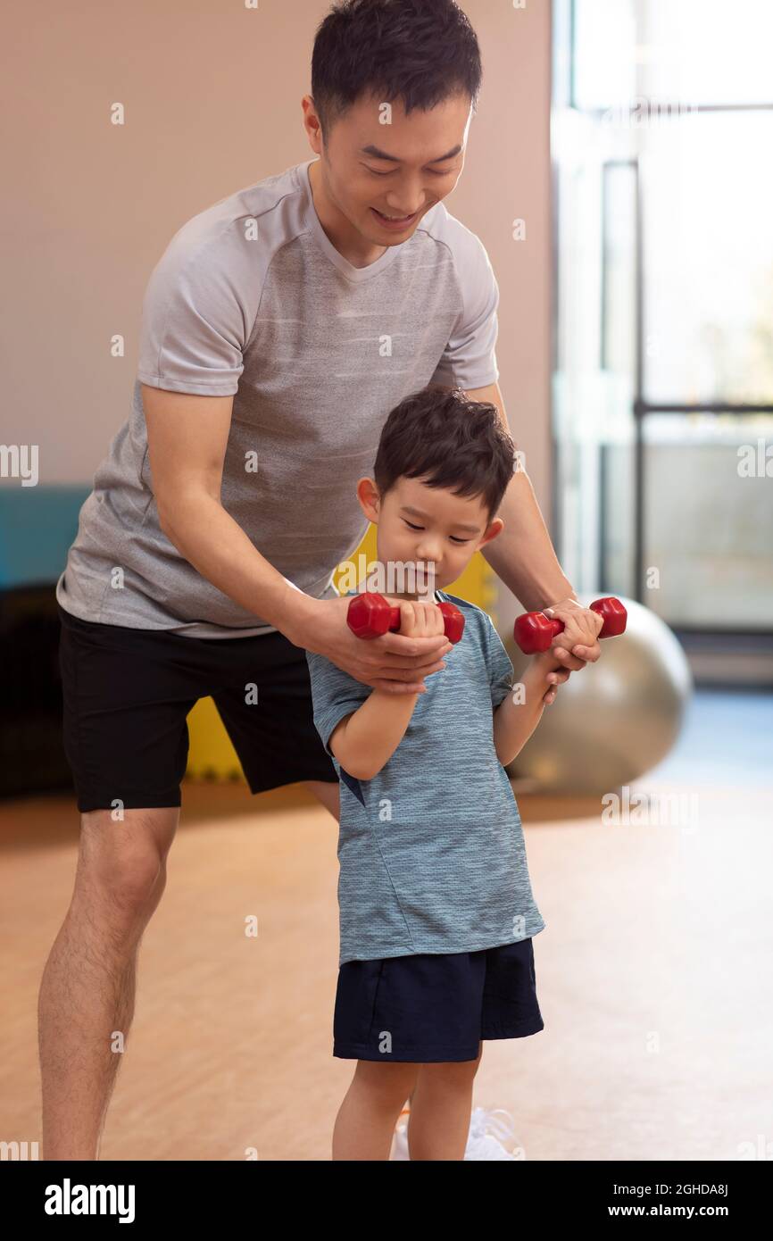 Little boy having exercise class in gym Stock Photo - Alamy