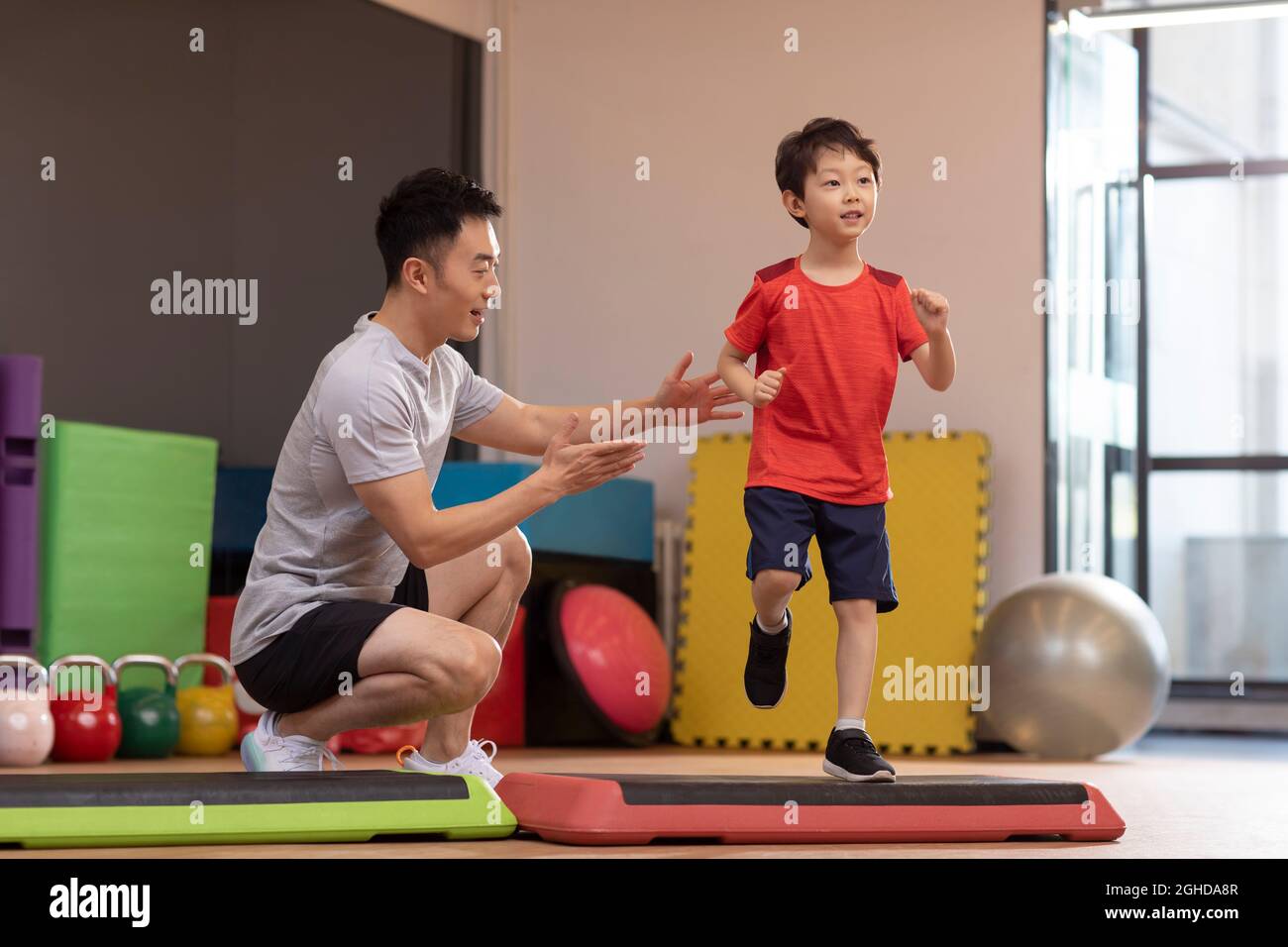 Little boy having exercise class in gym Stock Photo - Alamy