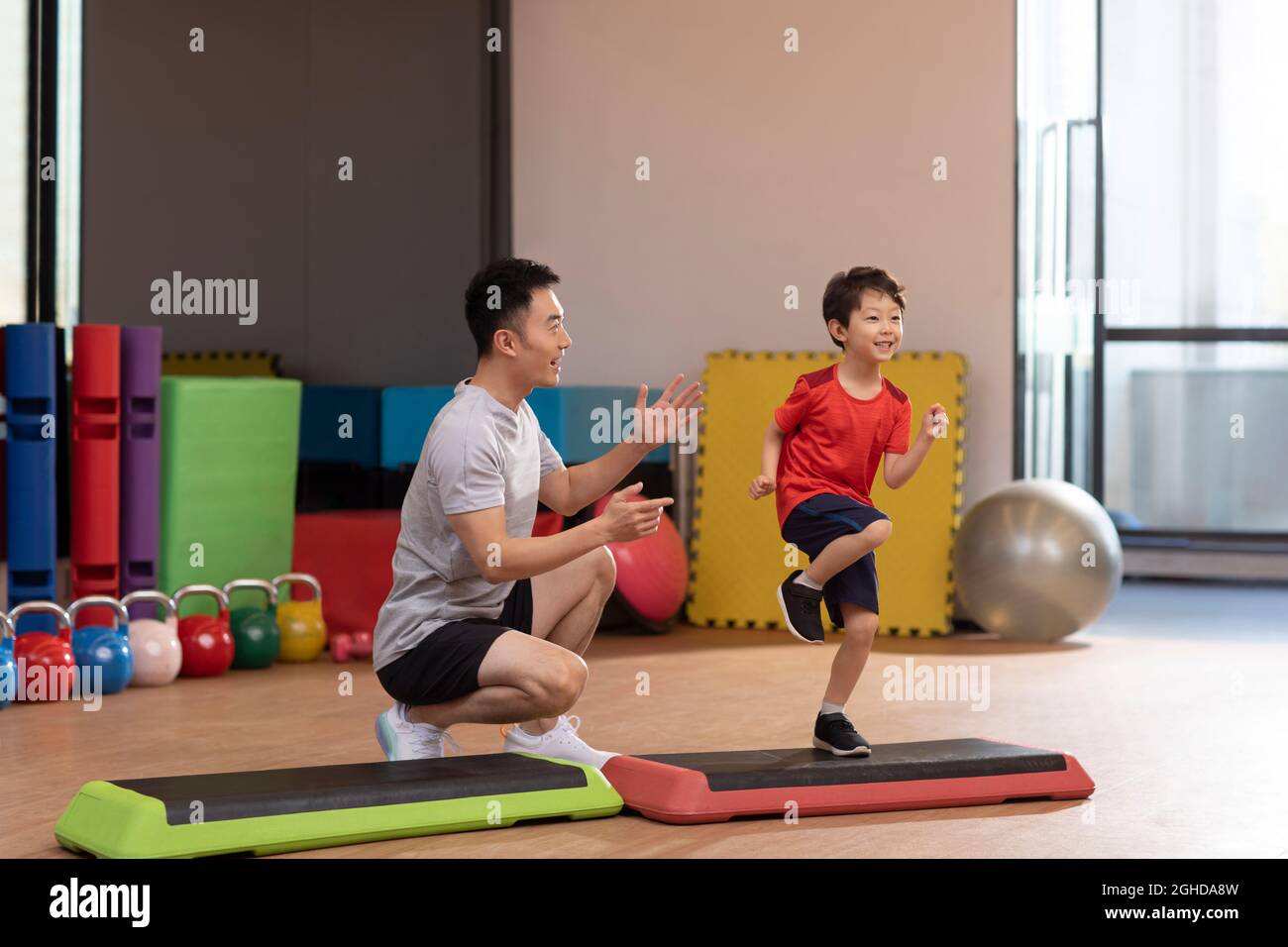 Little boy having exercise class in gym Stock Photo - Alamy