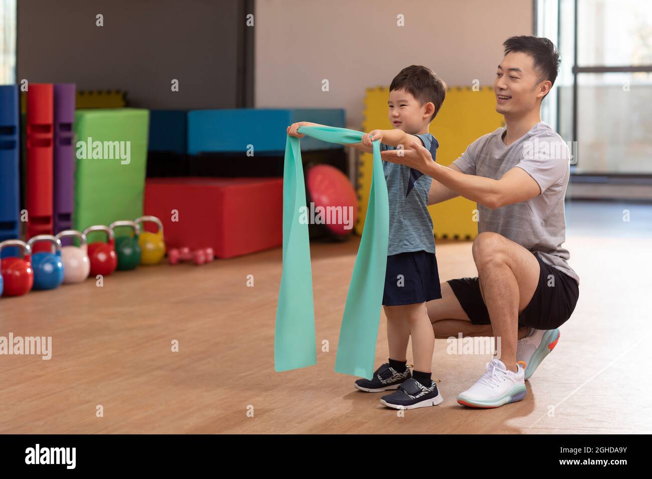Little boy having exercise class in gym Stock Photo - Alamy