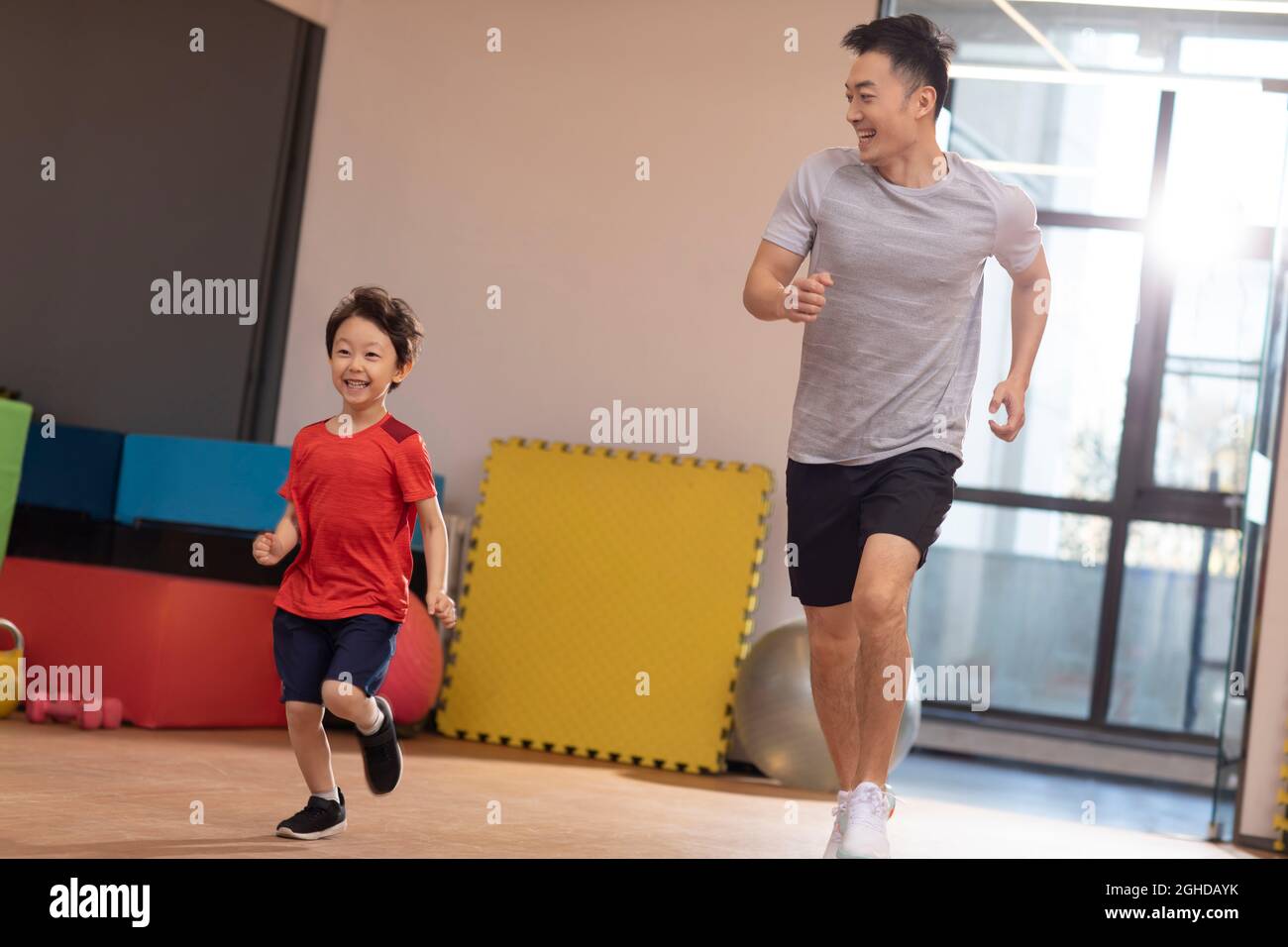 Little boy having exercise class in gym Stock Photo - Alamy