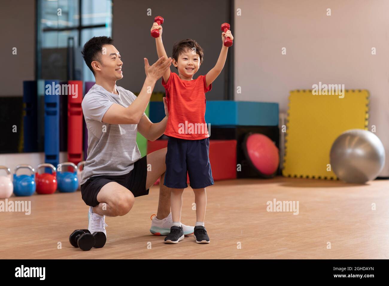 Little boy having exercise class in gym Stock Photo - Alamy