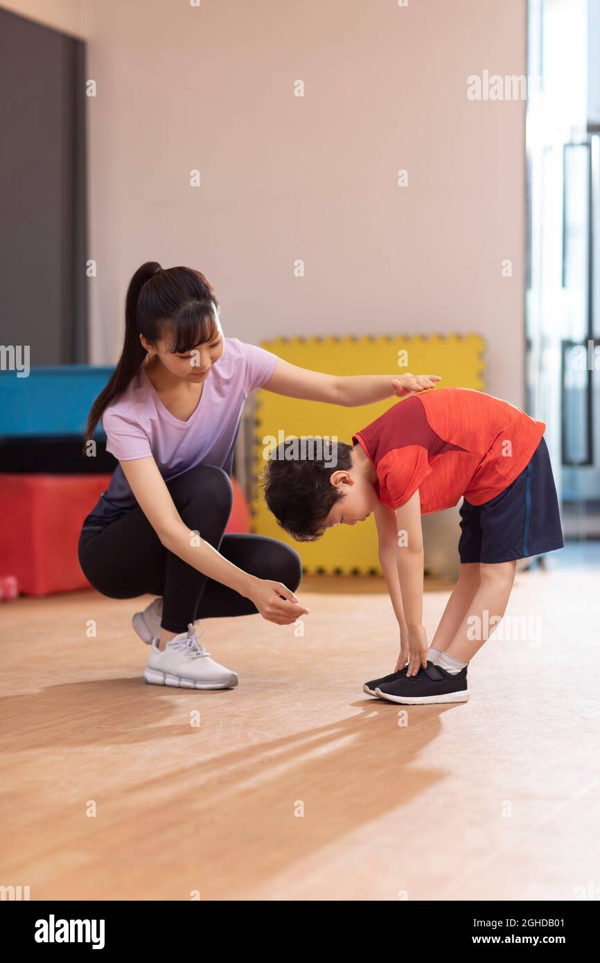Little boy having exercise class in gym Stock Photo - Alamy