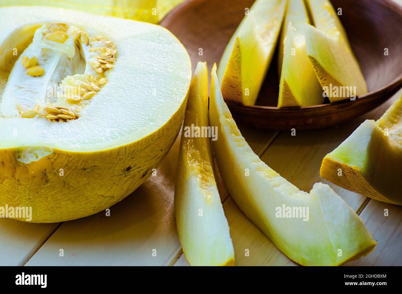 half and slices of ripe melon on a white background Stock Photo - Alamy