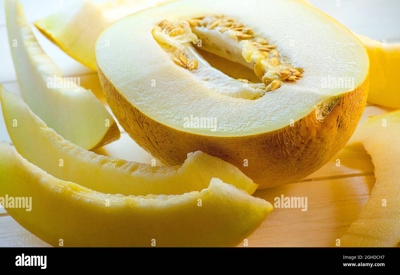 half and slices of ripe melon on a white background Stock Photo - Alamy