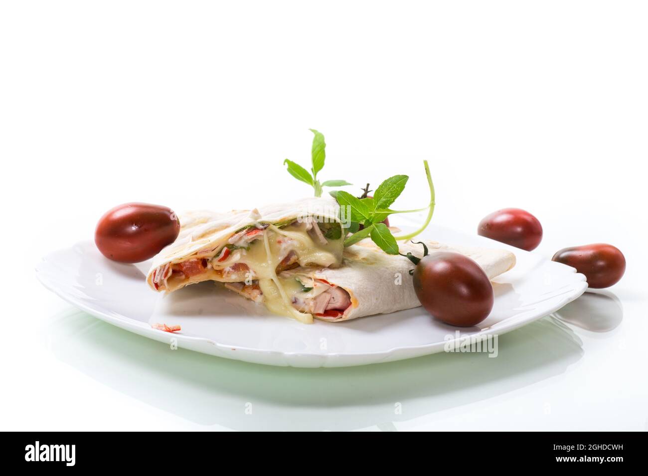 baked pita roll with filling in a plate isolated on white background ...