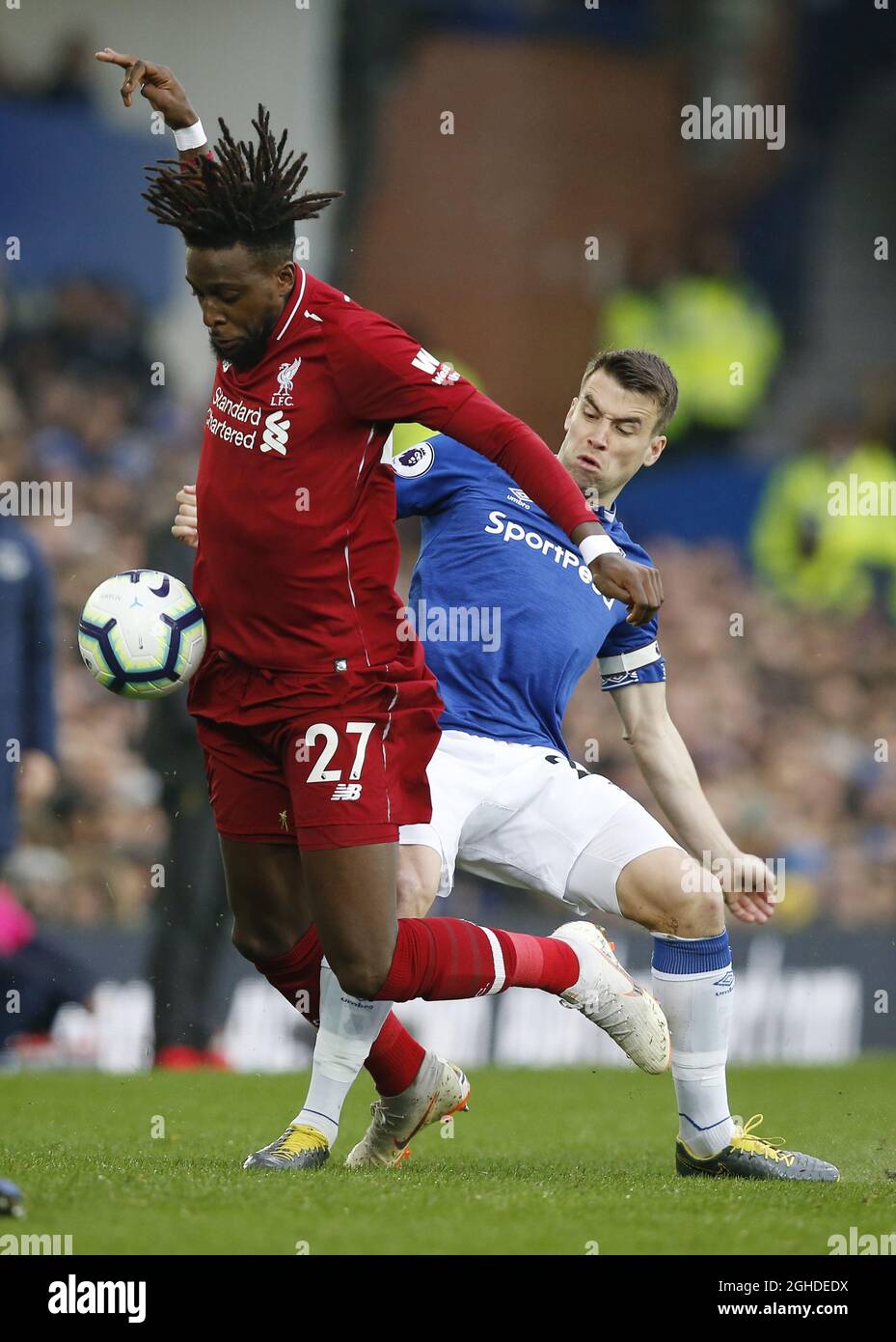 Seamus Coleman of Everton tackles Divock Origi of Liverpool during the ...