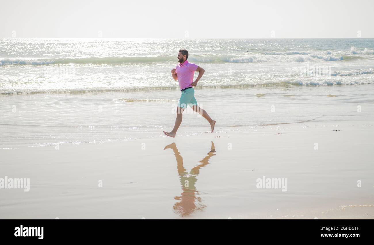 athletic man runner running barefoot on summer beach, sport Stock Photo ...