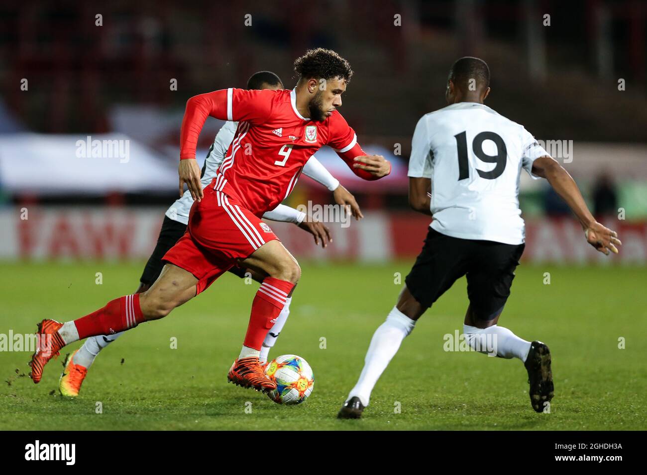 Tyler Roberts (L) of Wales runs away from Kevan George of Trinidad and ...