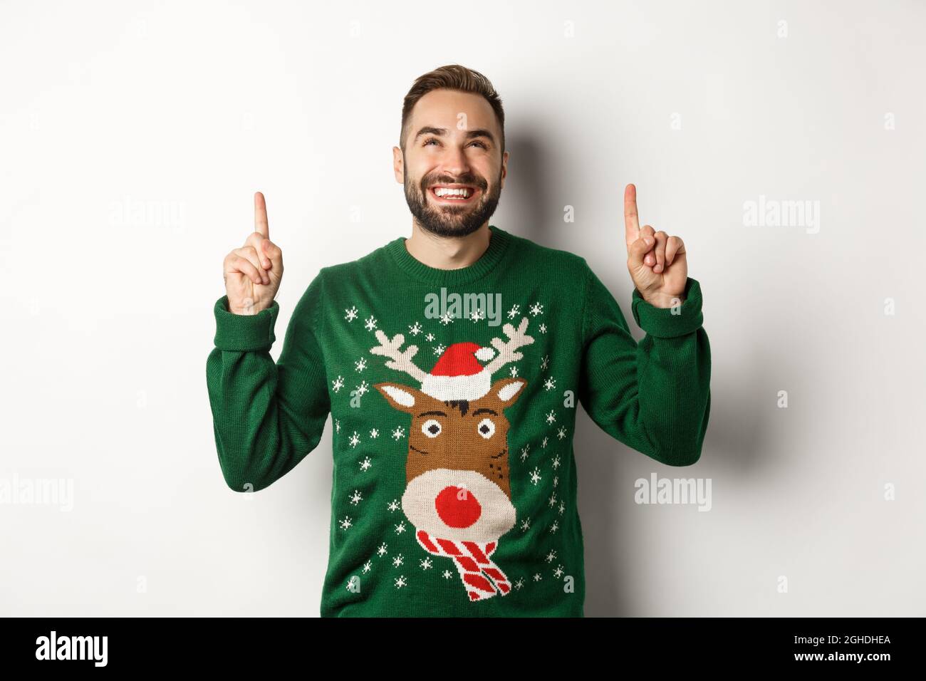 Winter holidays and christmas. Happy smiling man in funny sweater ...