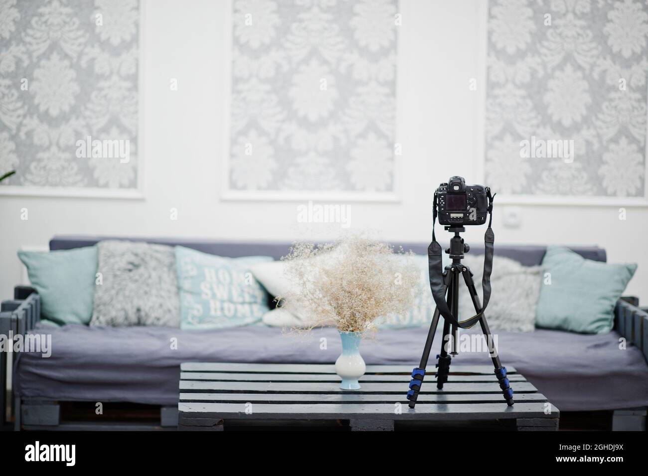 Camera on a tripod in cozy bedroom interior Stock Photo - Alamy