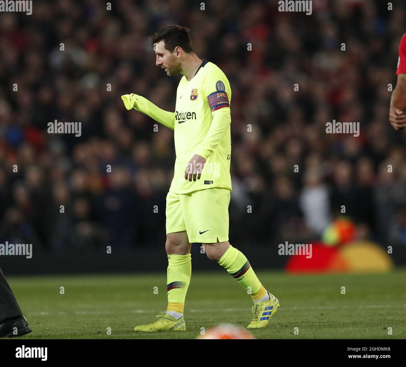 Lionel Messi of Barcelona looks at the blood on his shirt during the ...
