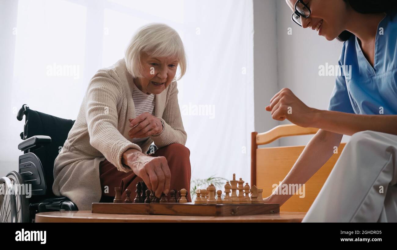 Elderly woman nurse playing board hi-res stock photography and images ...