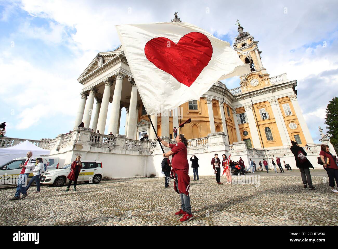 A giant flag is waved during the memorial service for the victims of ...