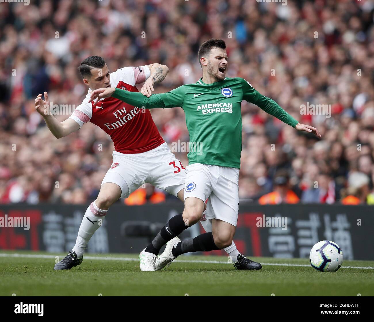 Arsenal's Granit Xhaka tussles with Brighton's Pascal Gross during the ...